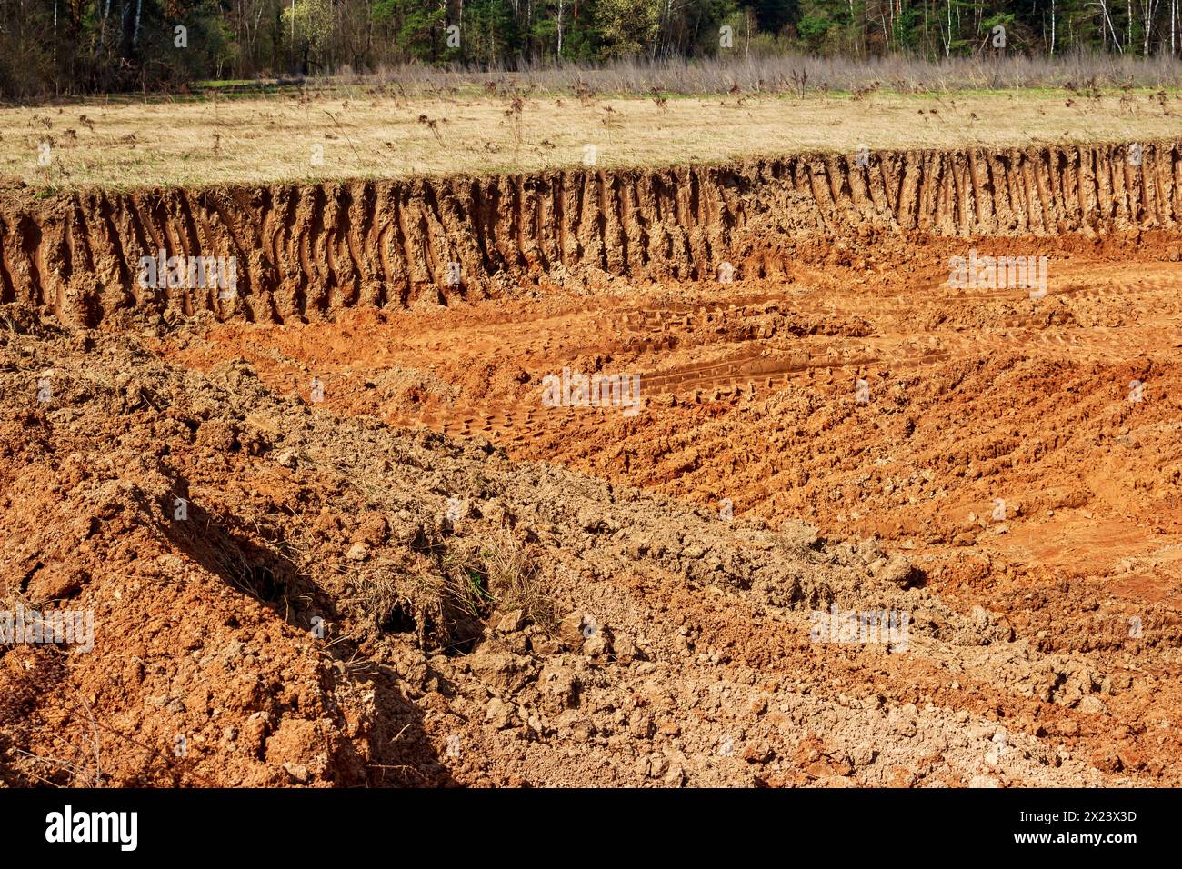 Removing overburden rocks in a sand quarry using an excavator, layers ...