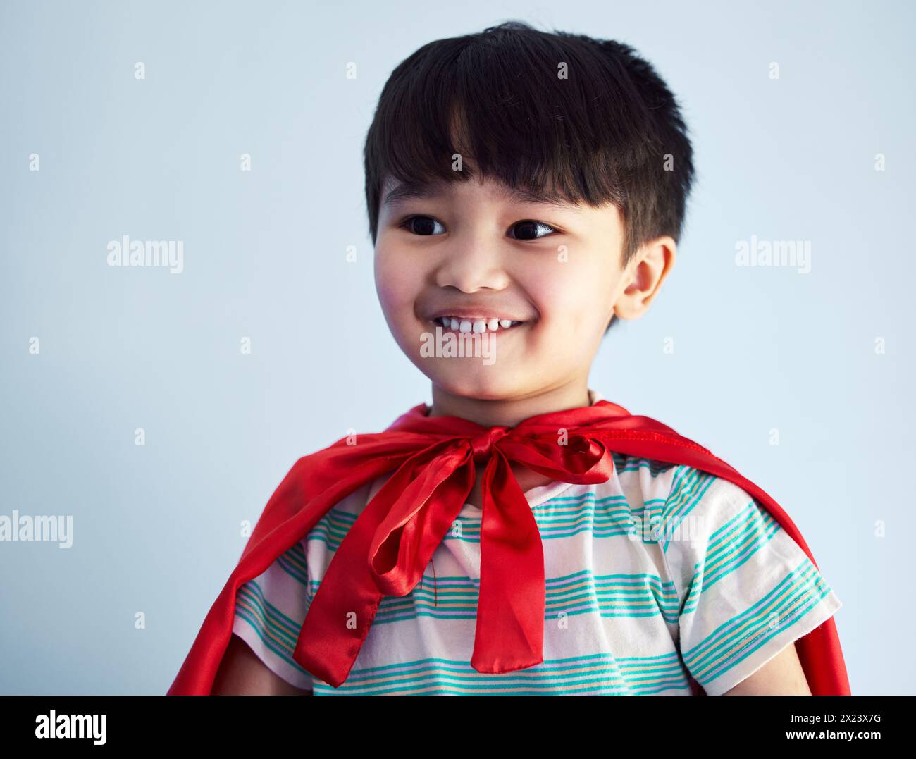 Studio, boy and superhero cape with smile for child development with ...