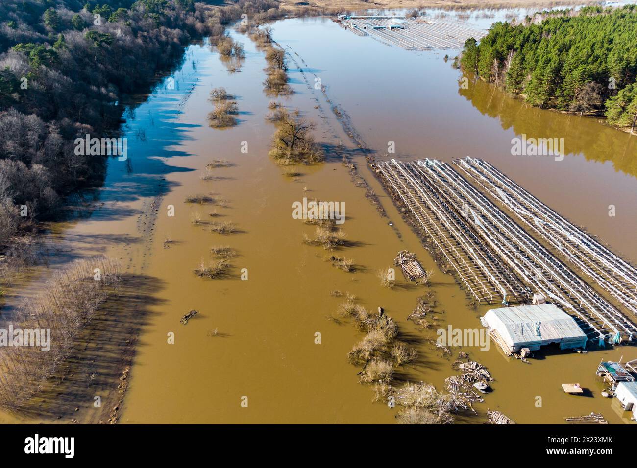 A river spill in a rural area from the air, large areas of land flooded ...