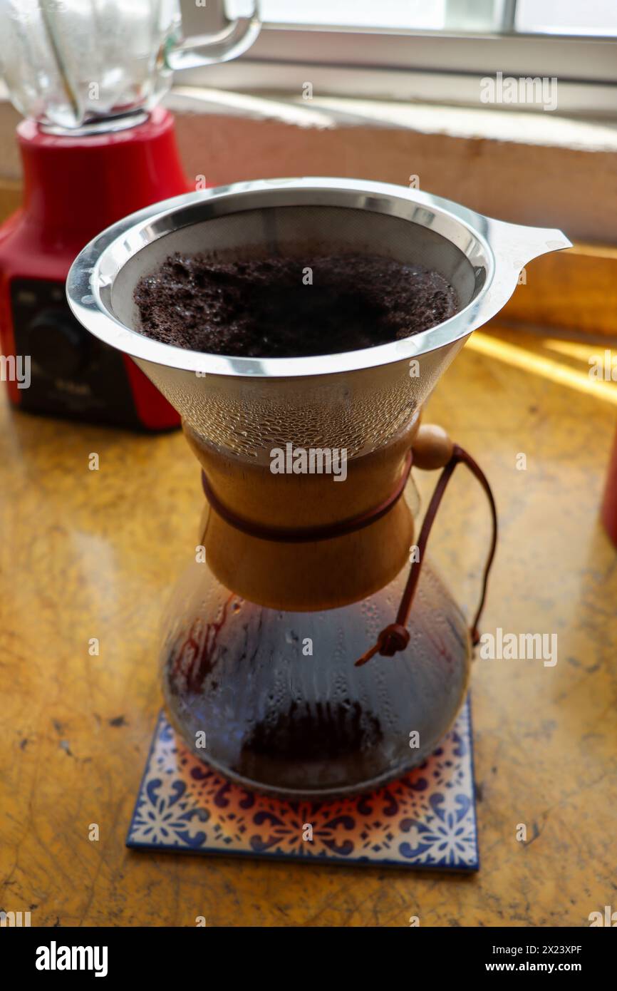 Glass pour over coffee maker on ceramic tile. Vertical shot, complete ...