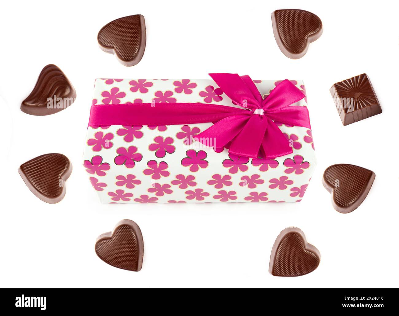 Chocolate candy and a box of chocolates in gift wrapping isolated on ...