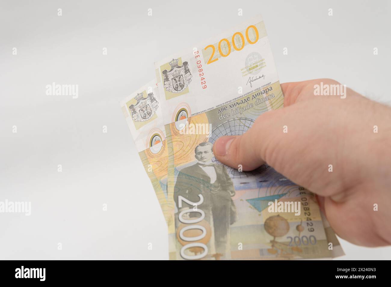 Man holding pile of money 2000 RSD Serbian Dinar banknote paper ...