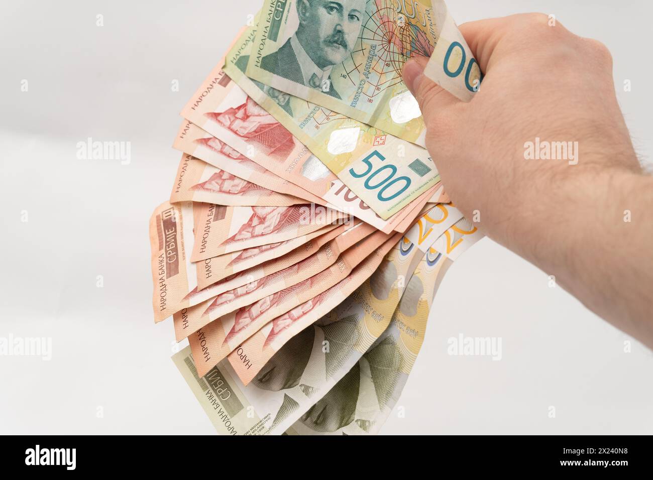 Man holding pile of money RSD Serbian Dinar banknote paper currency ...