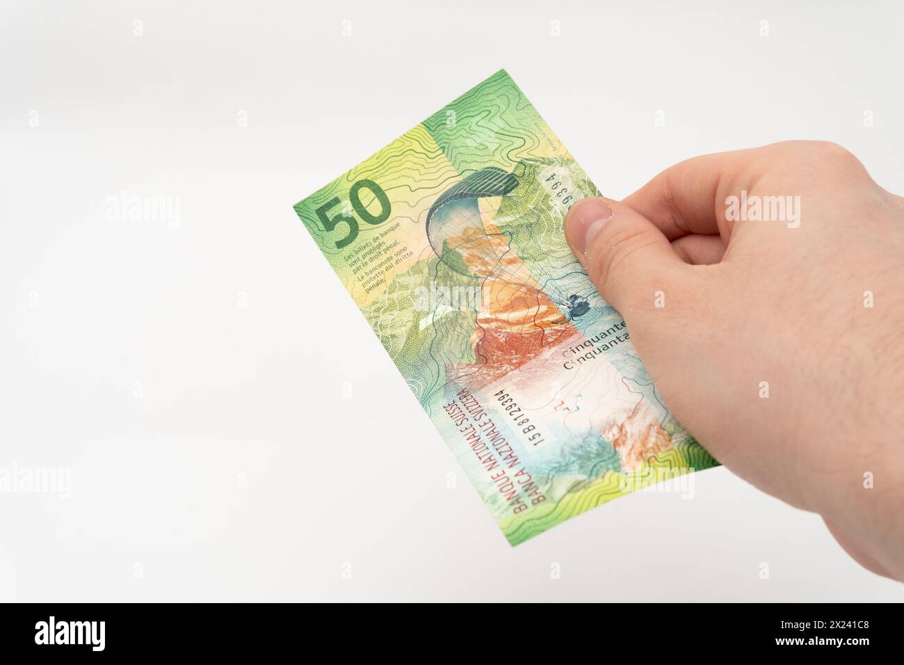 Man holding 50 CHF Swiss franc banknote paper currency isolated on ...