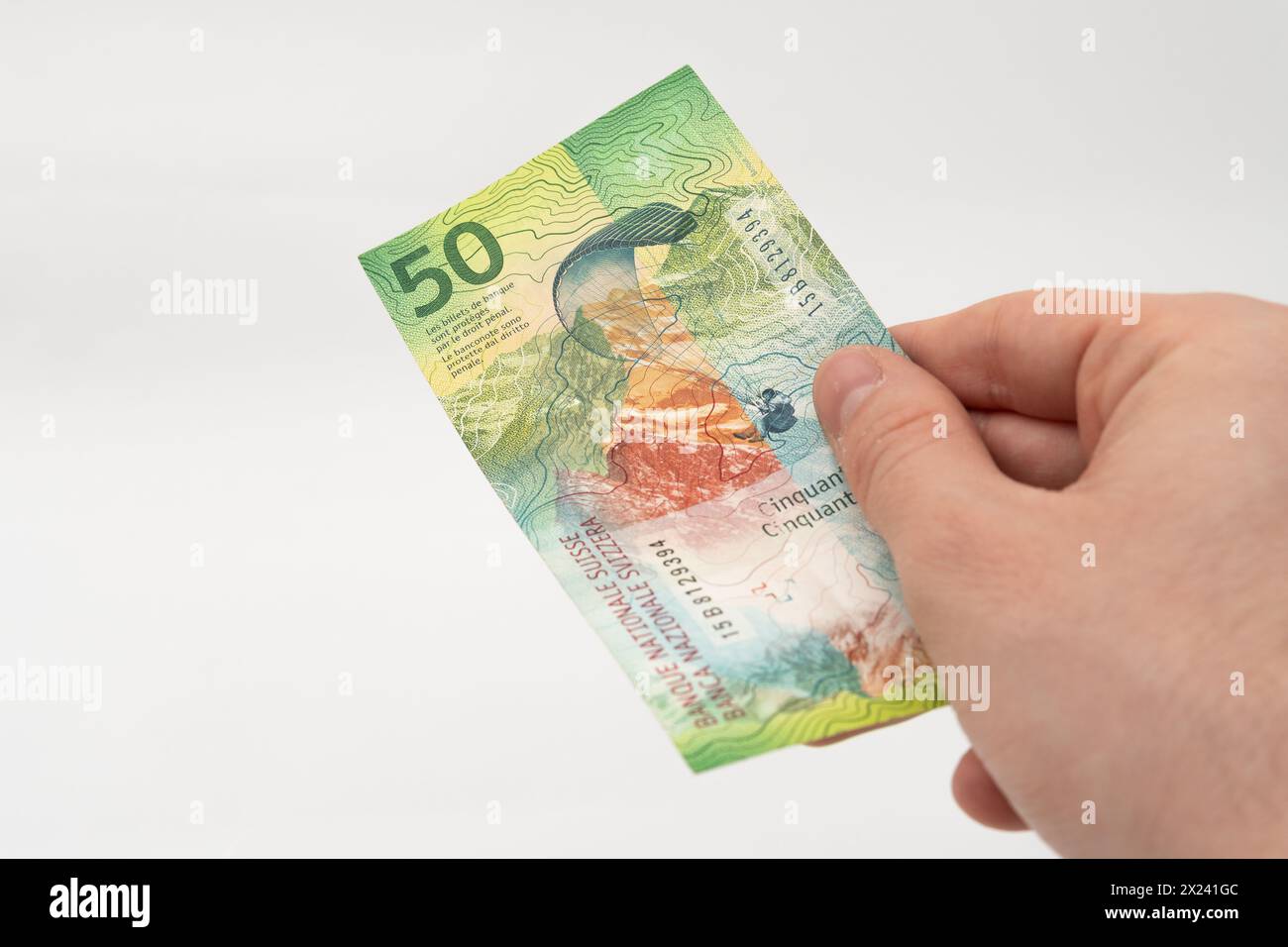 Man holding 50 CHF Swiss franc banknote paper currency isolated on ...