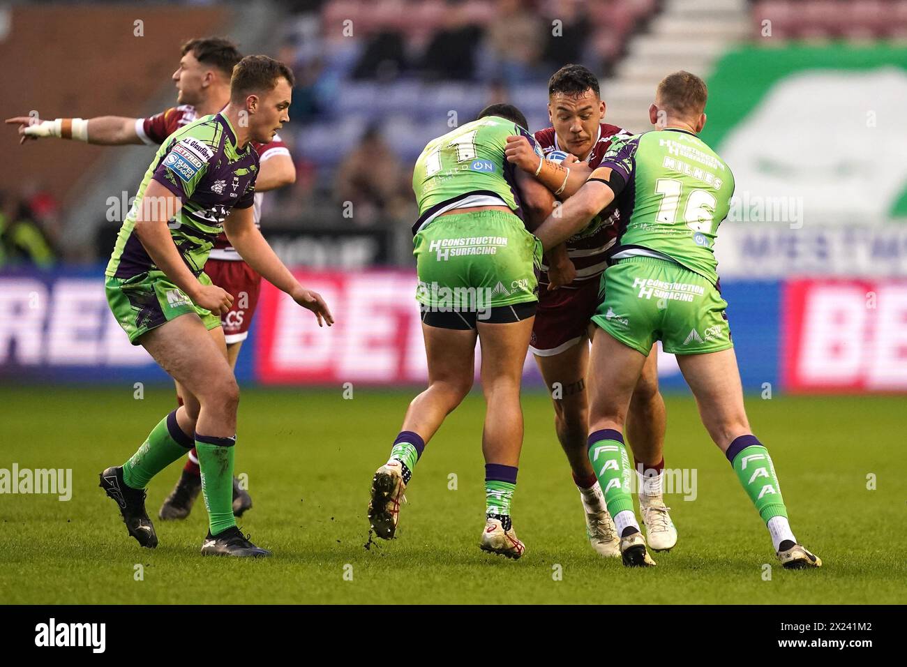 Wigan Warriors' Tyler Dupree is tackled by Castleford Tigers' Ellie El ...
