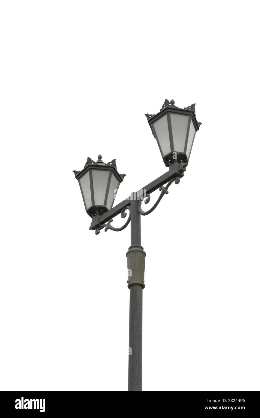 Street light with dual lanterns illuminating the night against a white ...