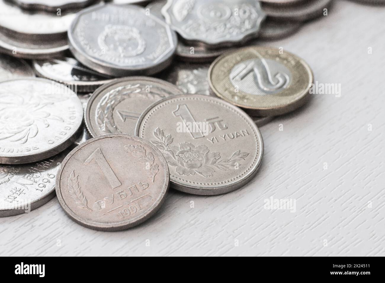 Coins of the Russian ruble, Chinese yuan, and other various coins close ...