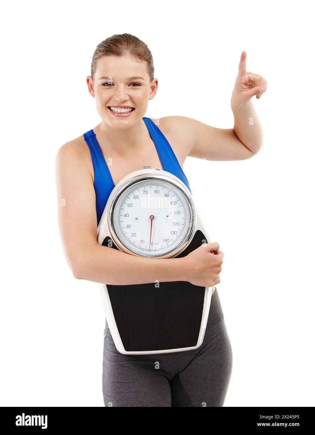 Portrait, woman and scale pointing up in studio background for ...