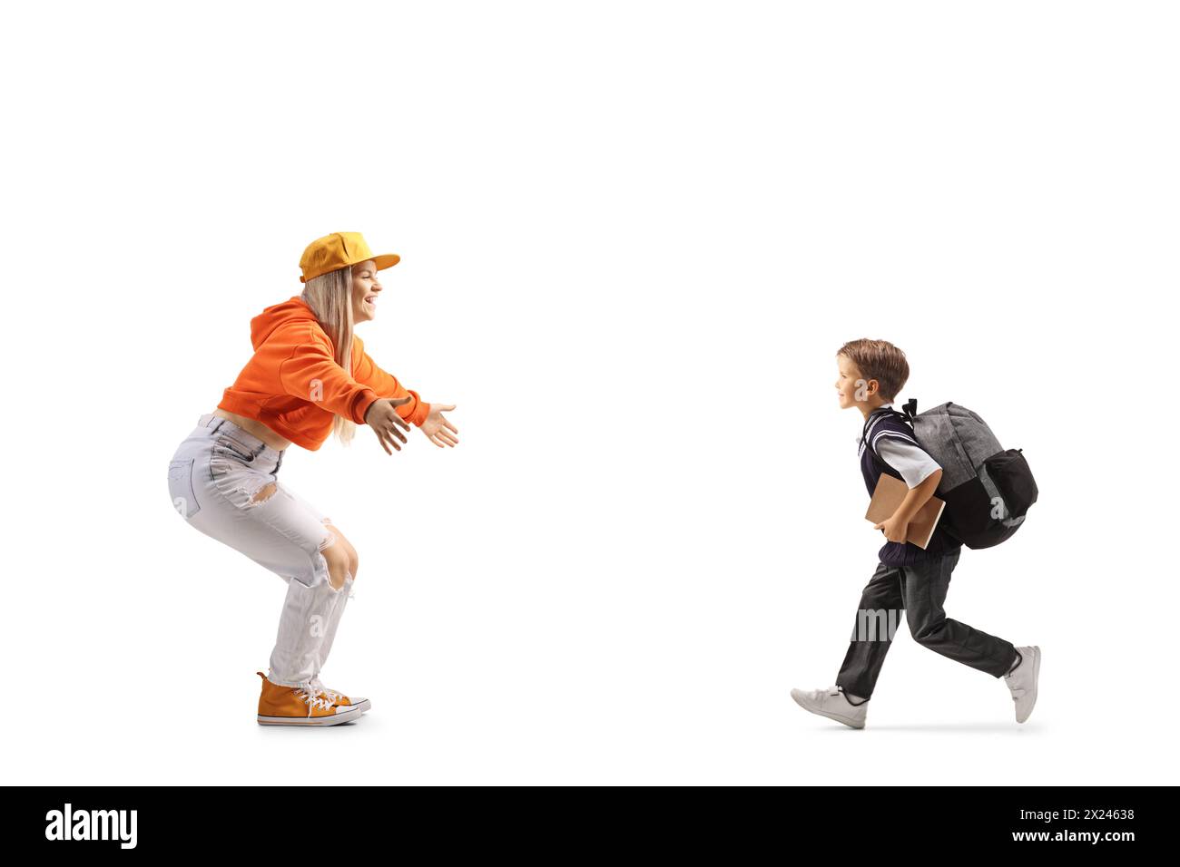 Full length profile shot of a schoolboy running to hug a young female ...