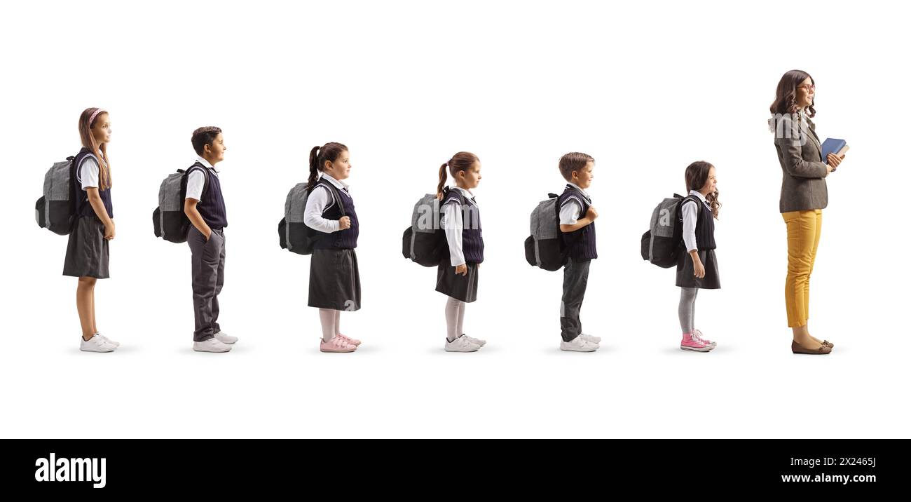 Full length profile shot of teacher and schoolchildren waiting in line ...