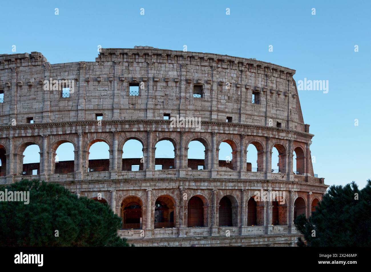 The Coliseum in the city center of Rome, Italy at twilight. It is an ...