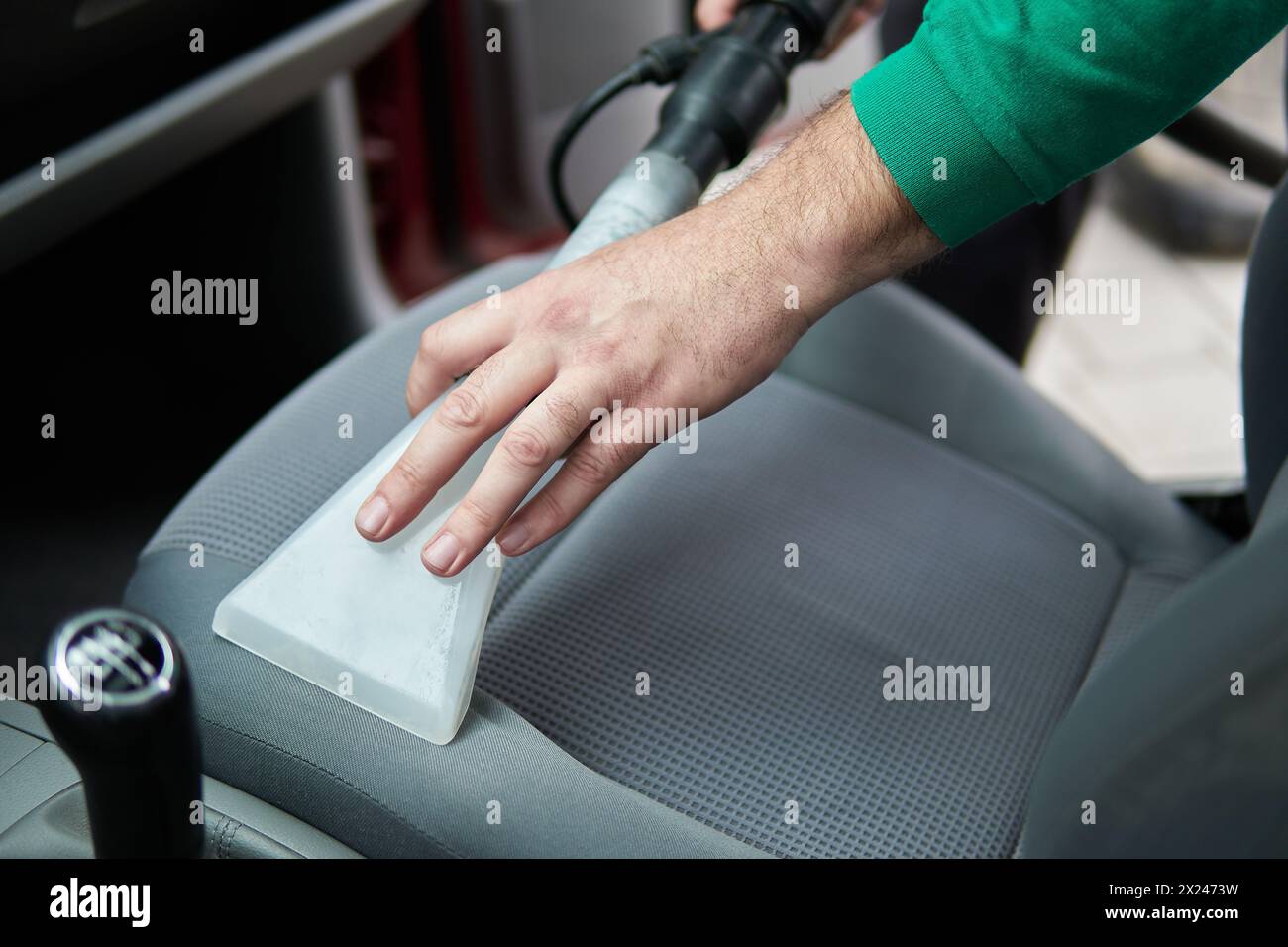 Car cleaning detailing - male using professional steam vacuum chemical ...