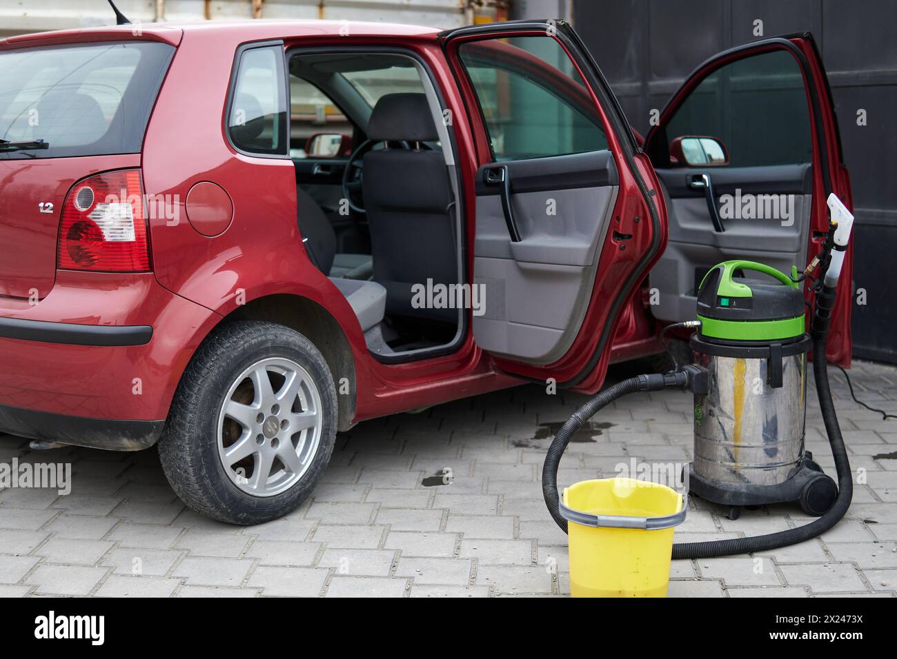 Professional extraction vacuum cleaner with car in background - Car ...