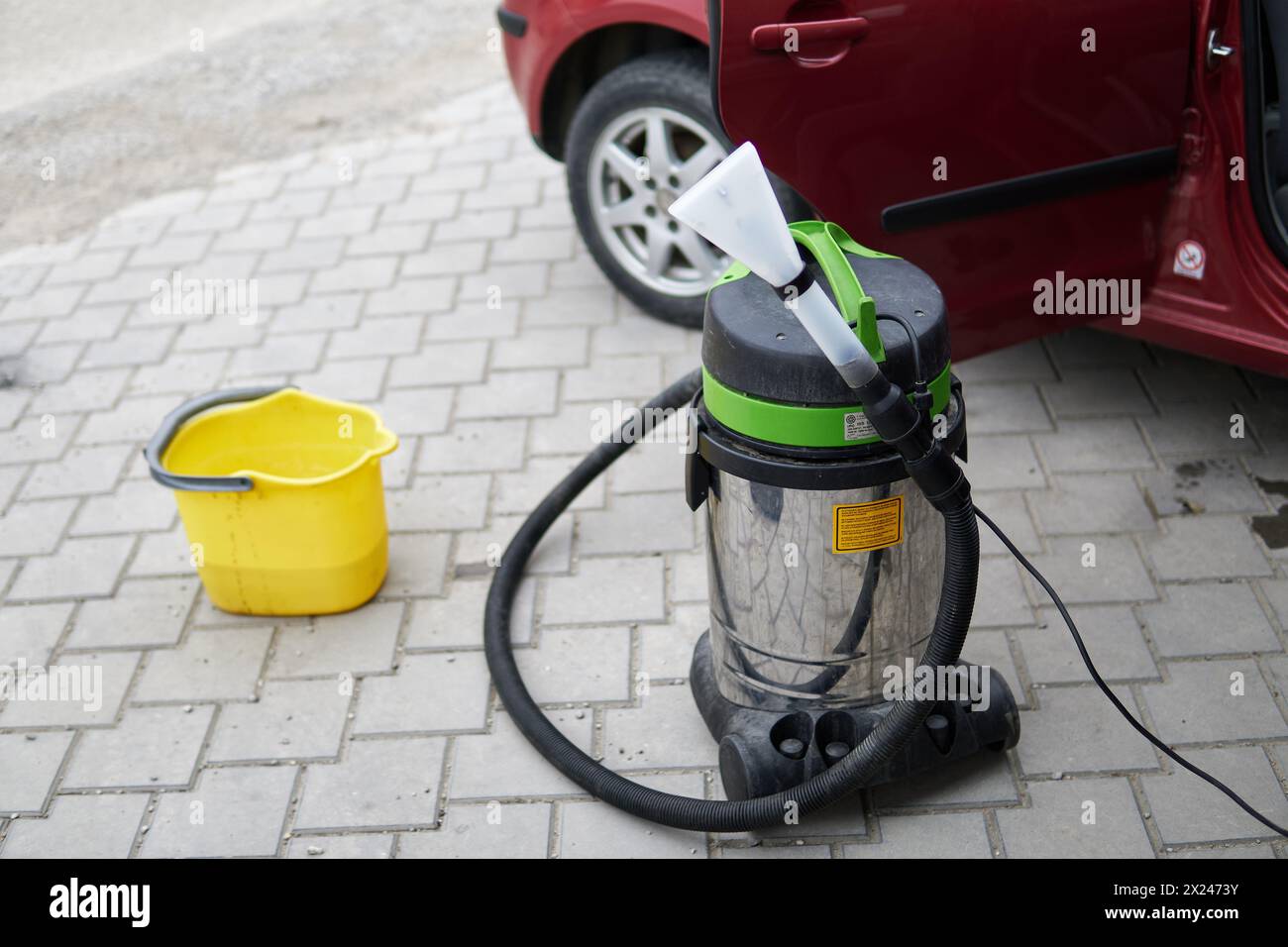 Professional extraction vacuum cleaner with car in background Stock ...