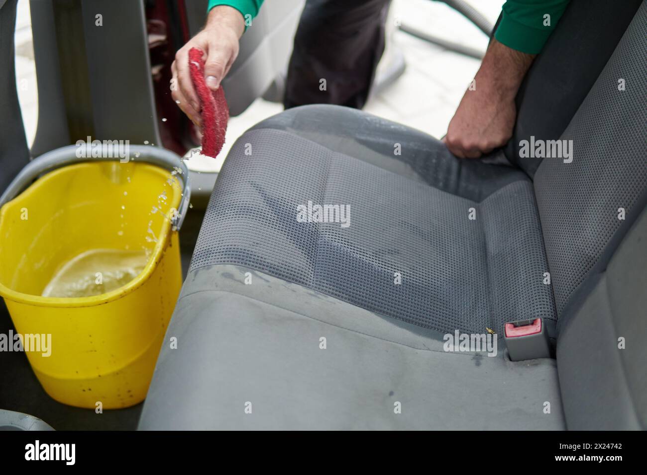 Car cleaning detailing - male using professional steam vacuum chemical ...