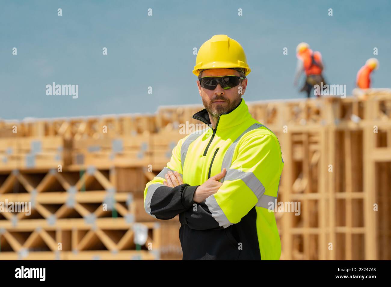 Portrait confident foreman in hard hat at new house under construction ...