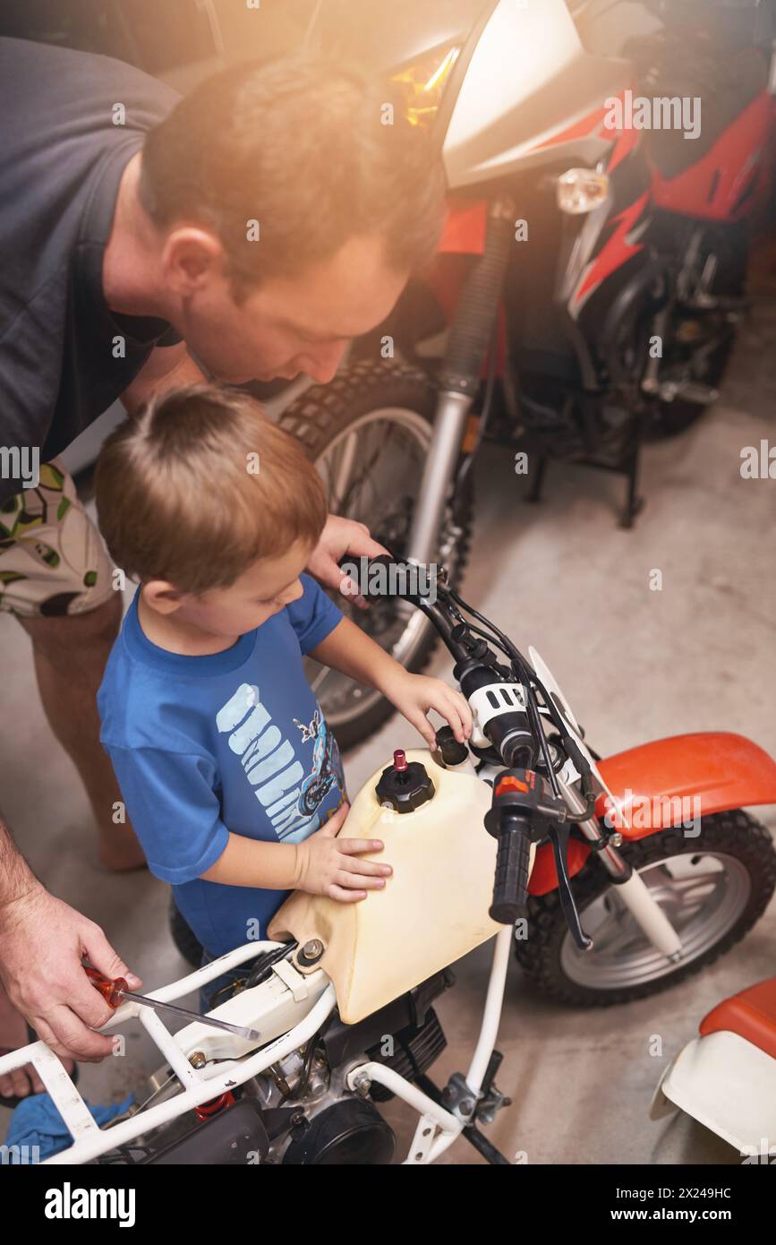 Dad, child and fixing with bike in garage at home for teamwork, support ...