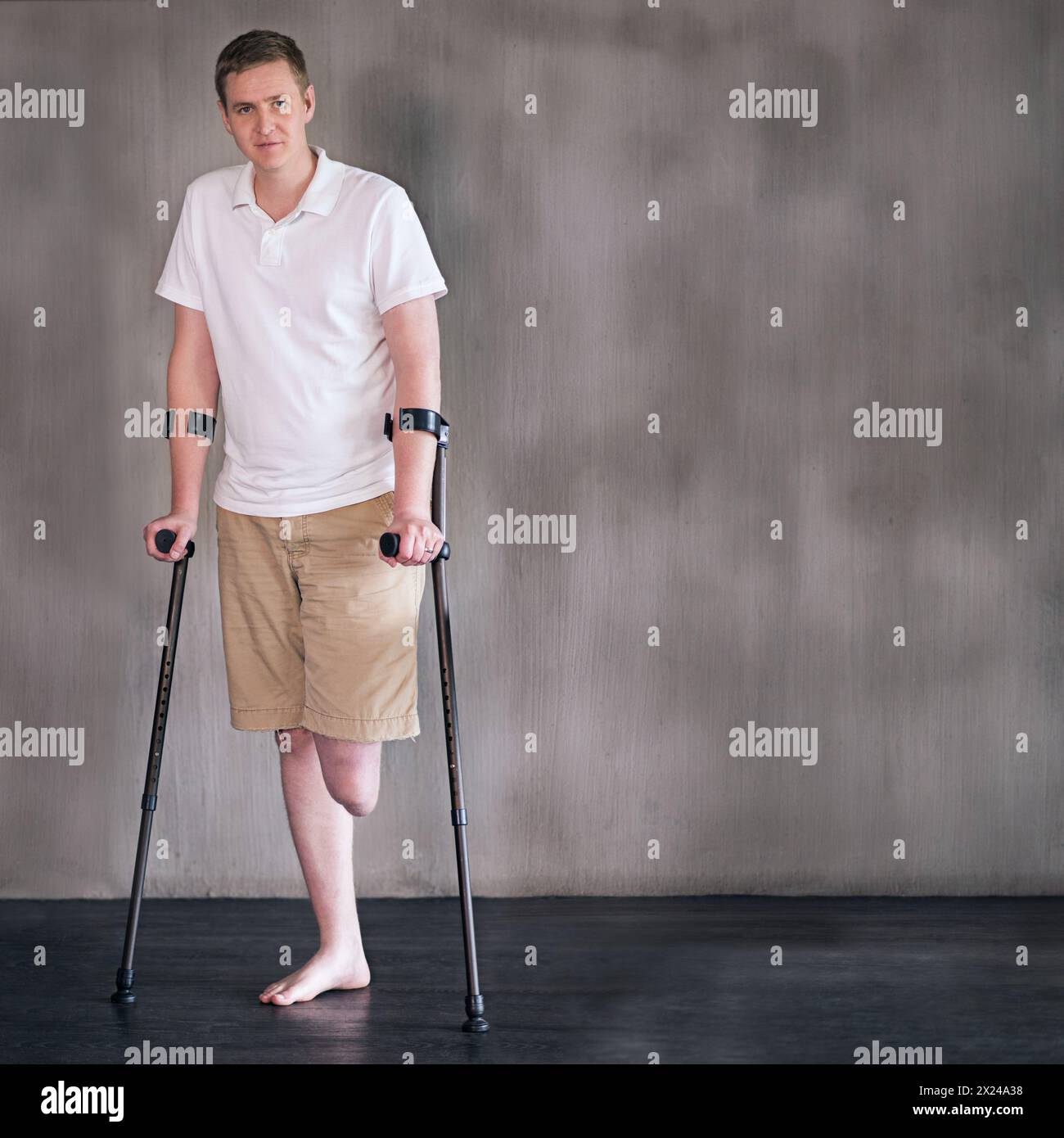 Portrait, crutches and man with disability in healthcare centre for ...