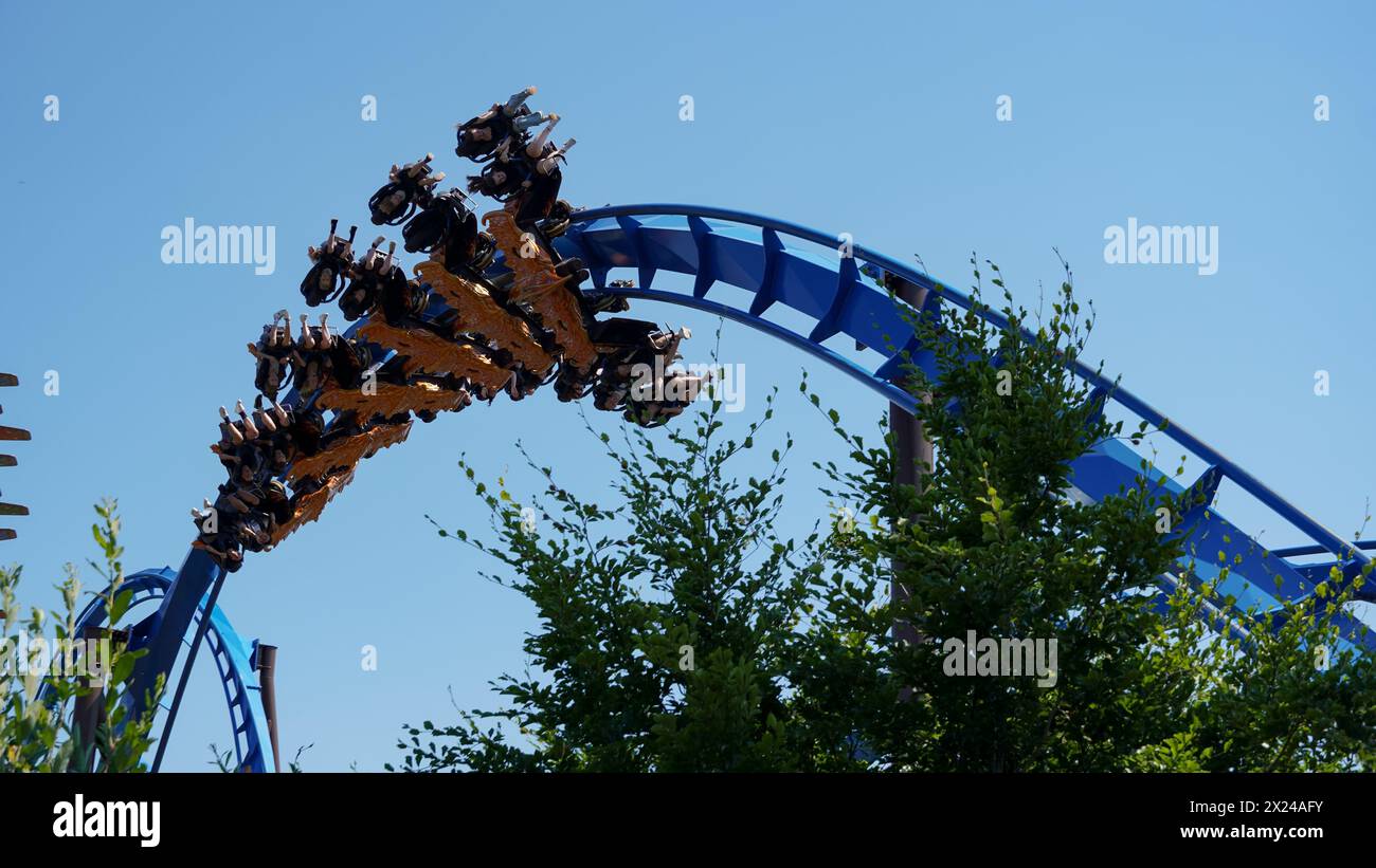 Young people have fun on the "Fenix" wing rollercoaster at the ...
