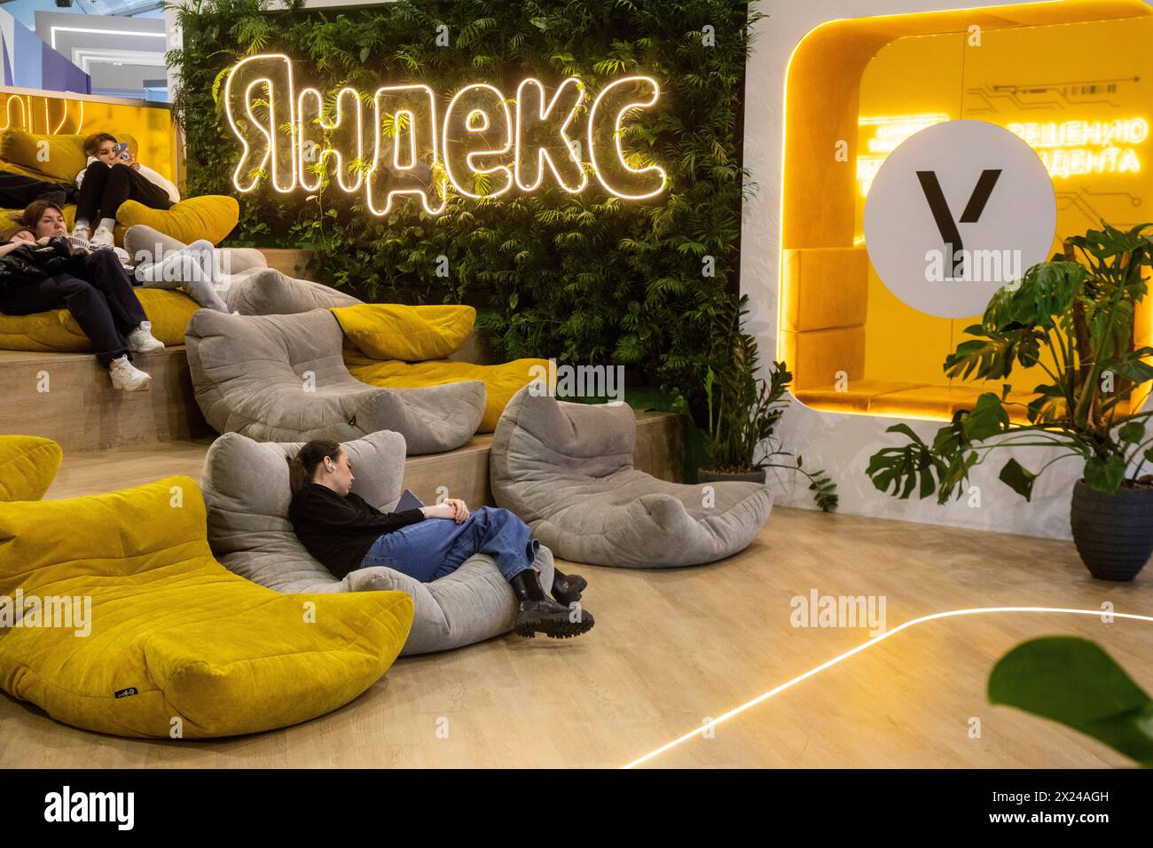 Moscow, Russia. 19th of April, 2024. Visitors relax at the Yandex stand ...