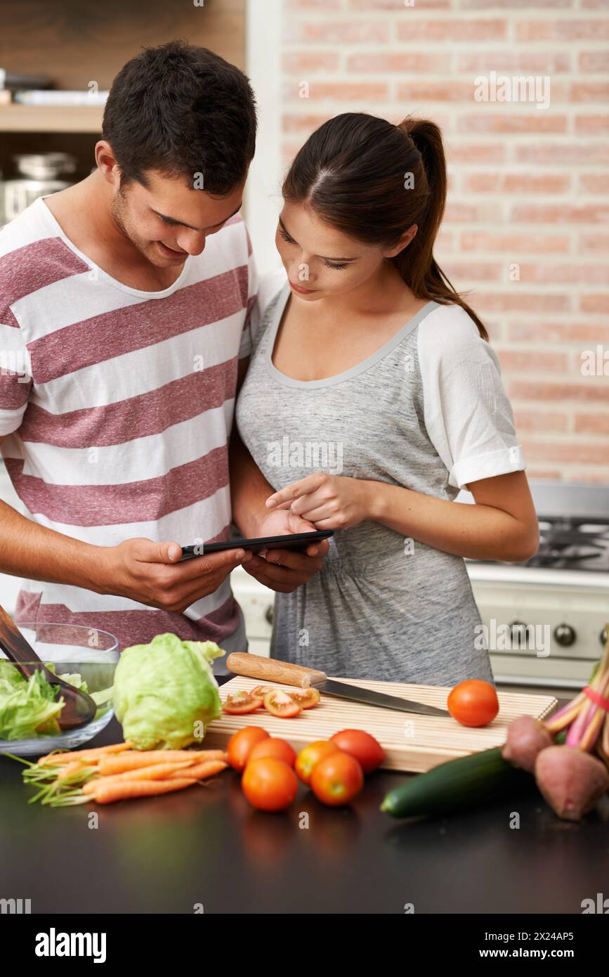 Cooking tutorial, tablet and couple in kitchen for healthy food or ...