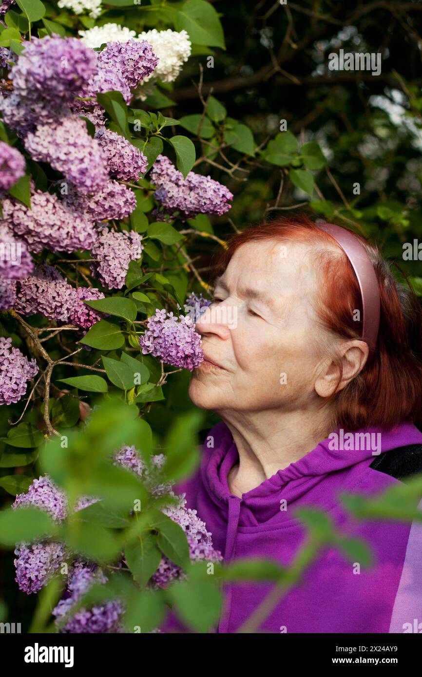 Outdoor close-up portrait of old woman. Beautiful elderly woman against ...
