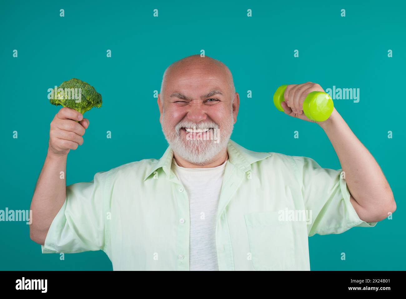 Healthy Senior. Healthy food. Power old mature man hold dumbbell and ...