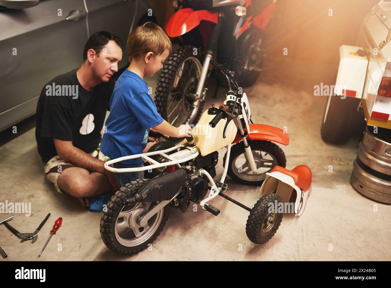 Parent, child and fixing bike in garage at home for teamwork, support ...