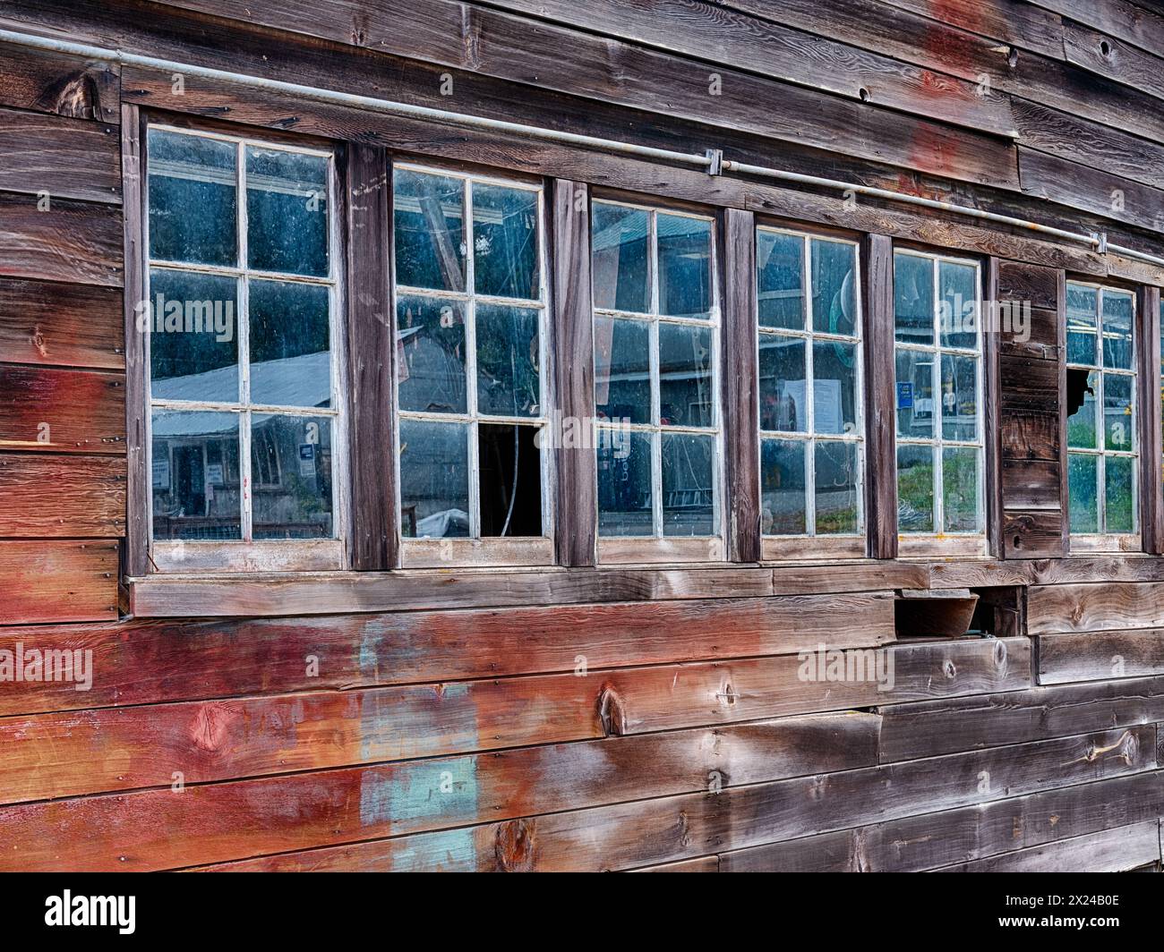Old dusty windows at the Jensen boat house on San Juan Island let in ...