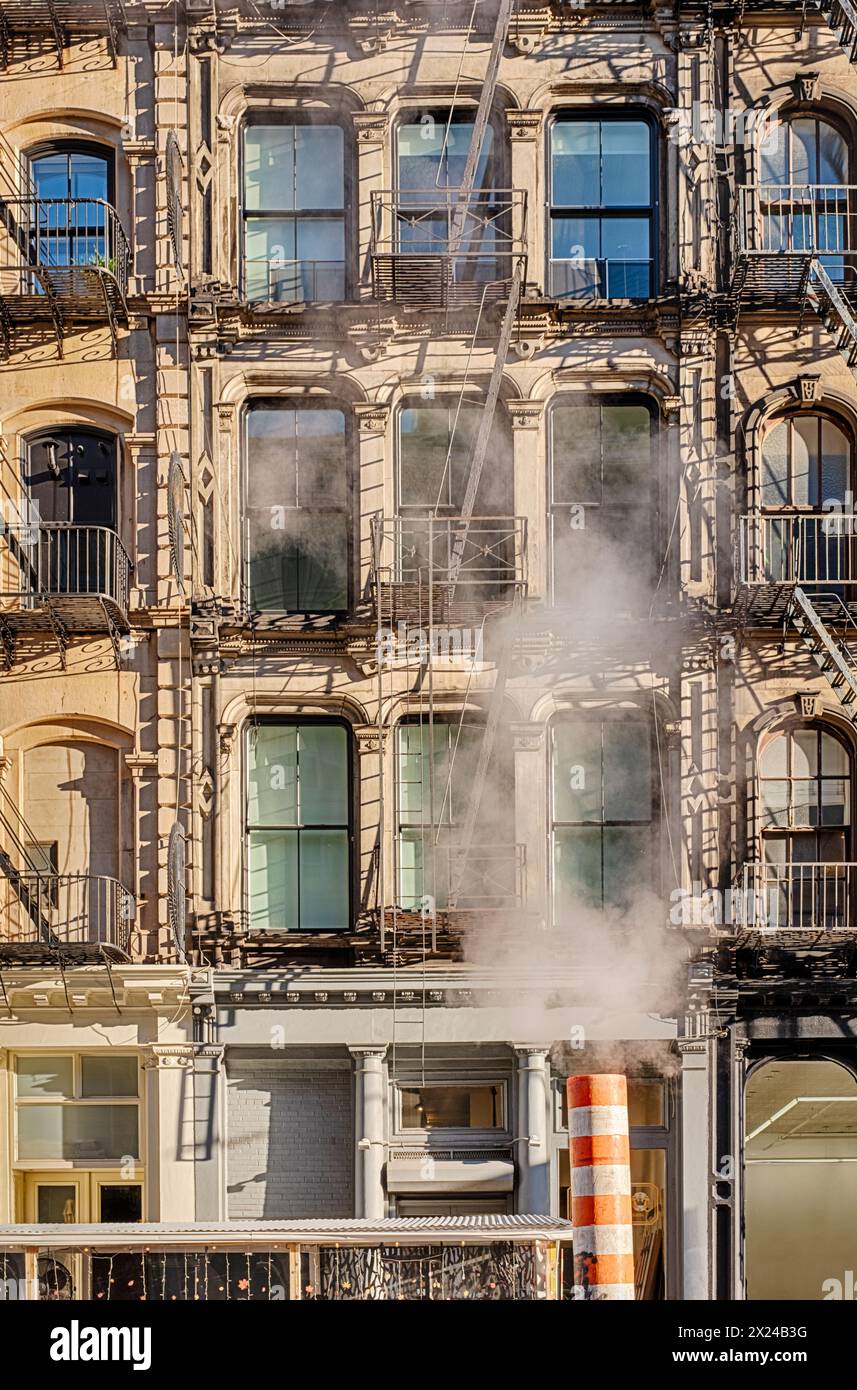 A non-descript building with a fire escape is fronted by a red and ...