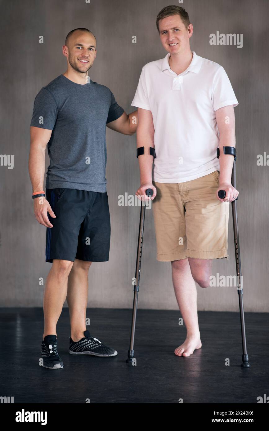 Physiotherapy, crutches and man with disability in portrait for walking ...