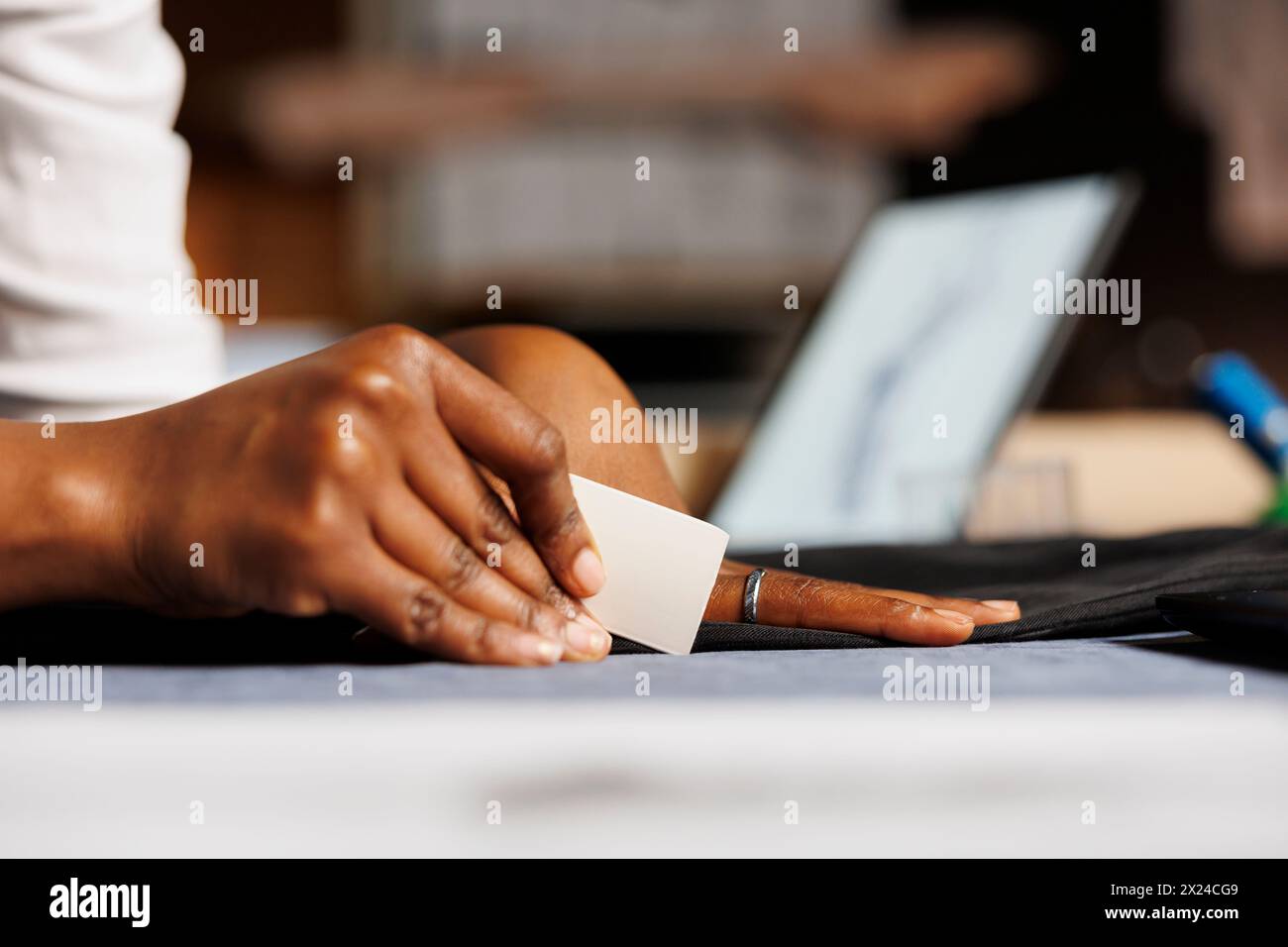 Extreme close up of african american seamstress precisely checking ...