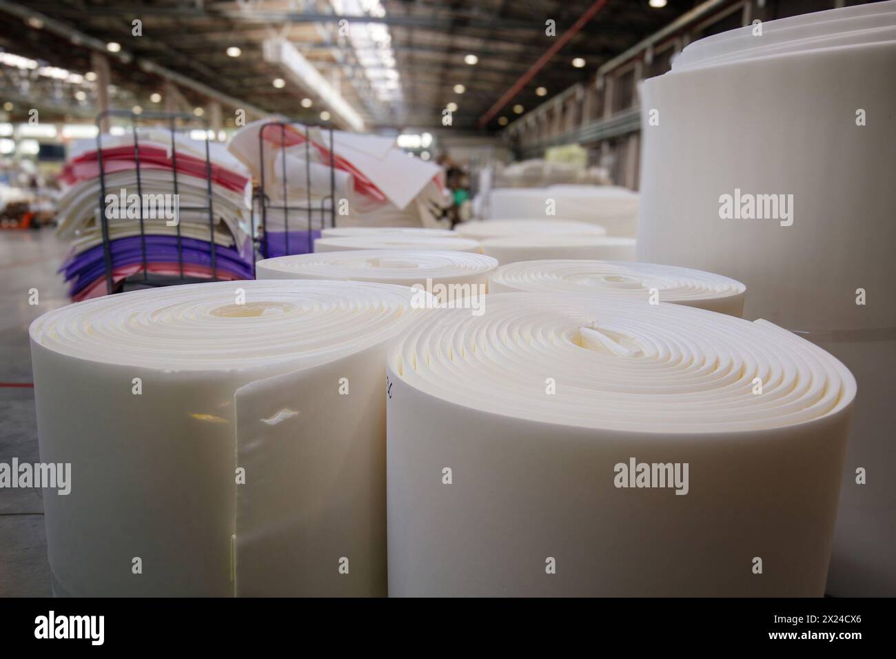 Packs of rolled foam rubber in warehouse Stock Photo - Alamy