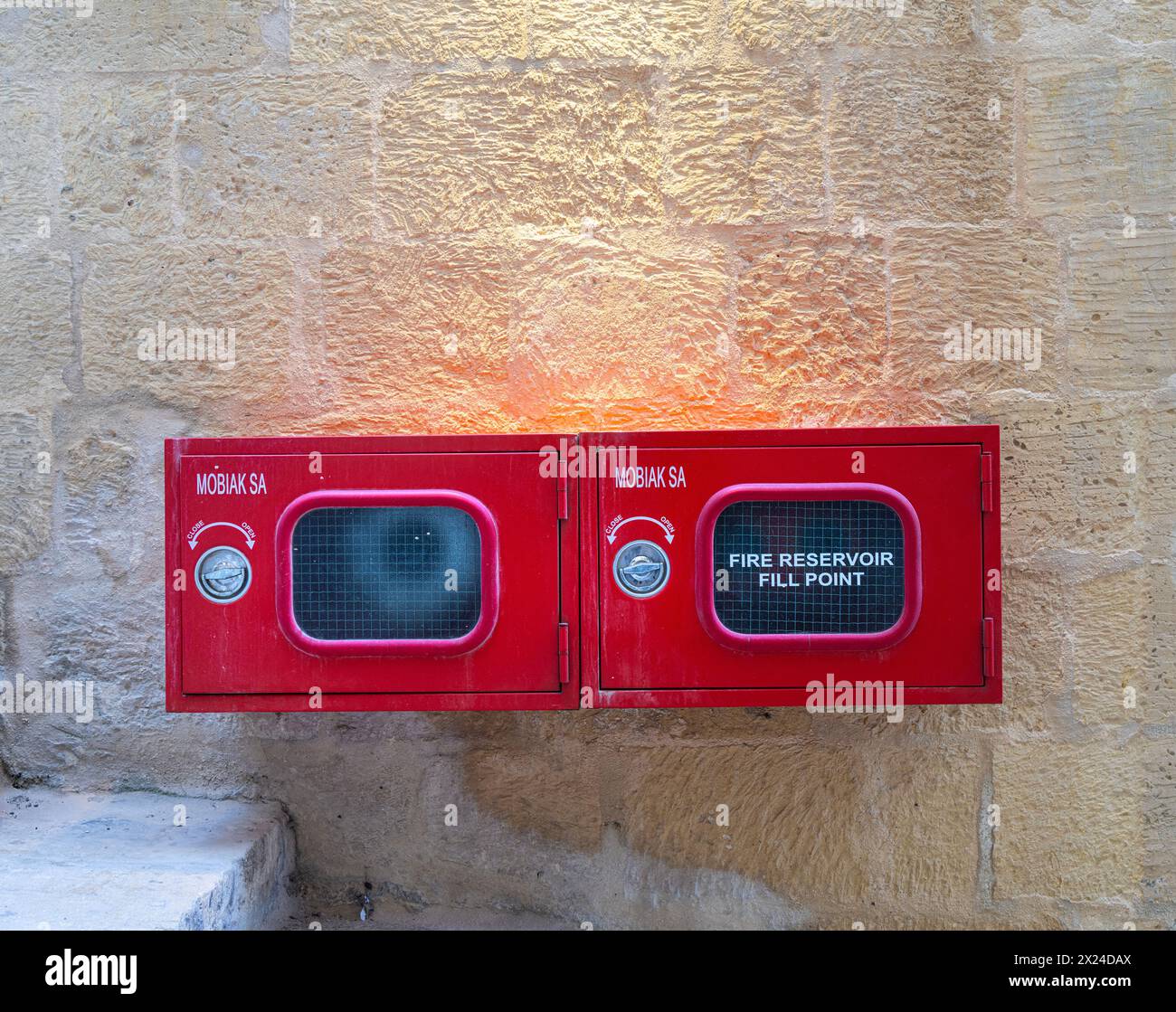 Valletta, Malta, April 03, 2024. fire hose container on a wall in the ...