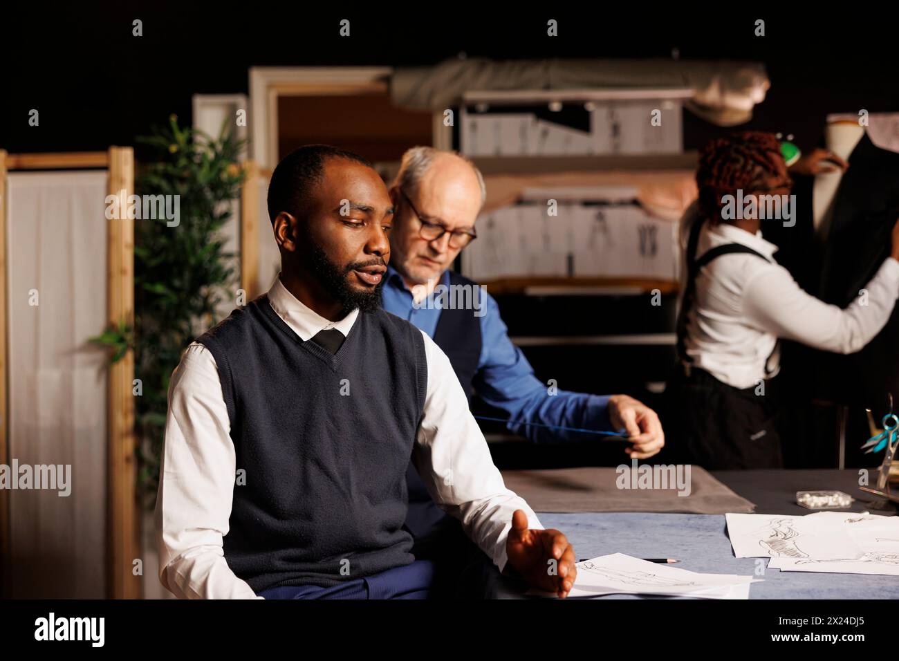 Master tailor taking client measurements while meticulous seamstress ...