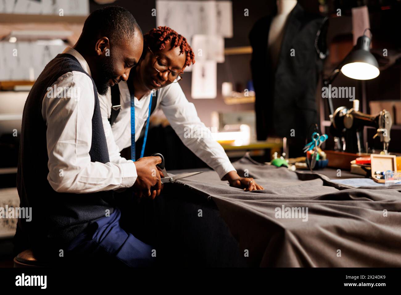 Experienced african american atelier shop coworkers meticulously ...