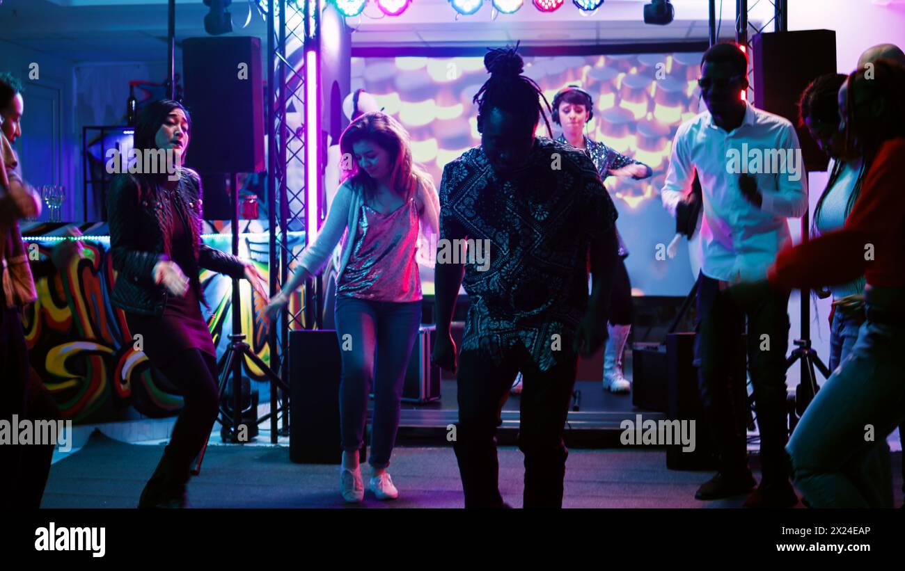 Happy persons jumping at dance party, having fun at social gathering in ...