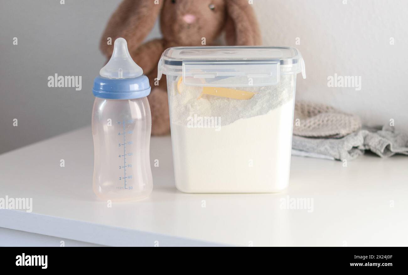 Dry powder formula milk for feeding babies in a can with yellow plastic ...
