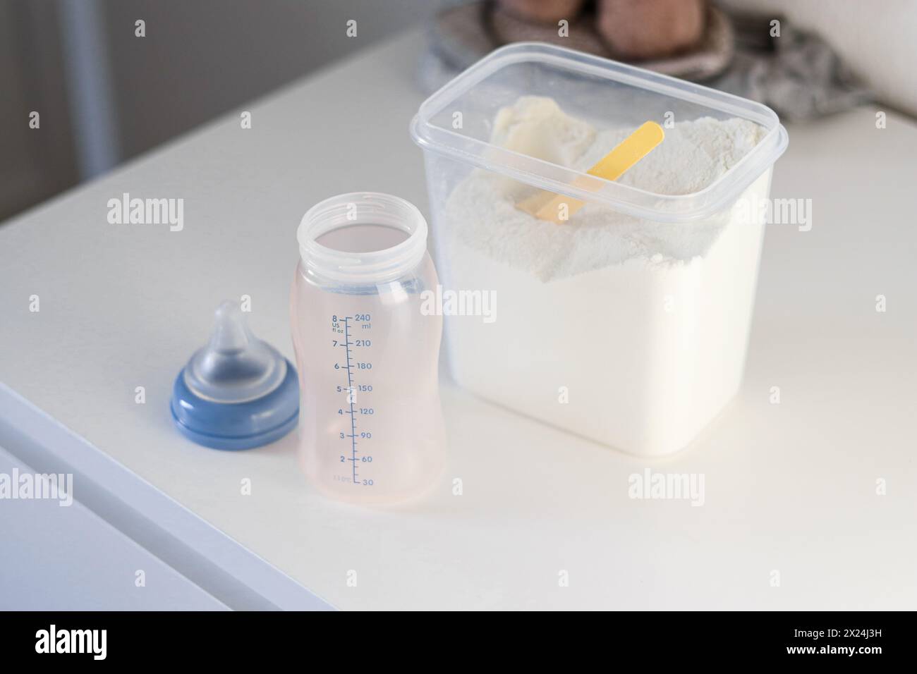 Dry powder formula milk for feeding babies in a can with yellow plastic ...