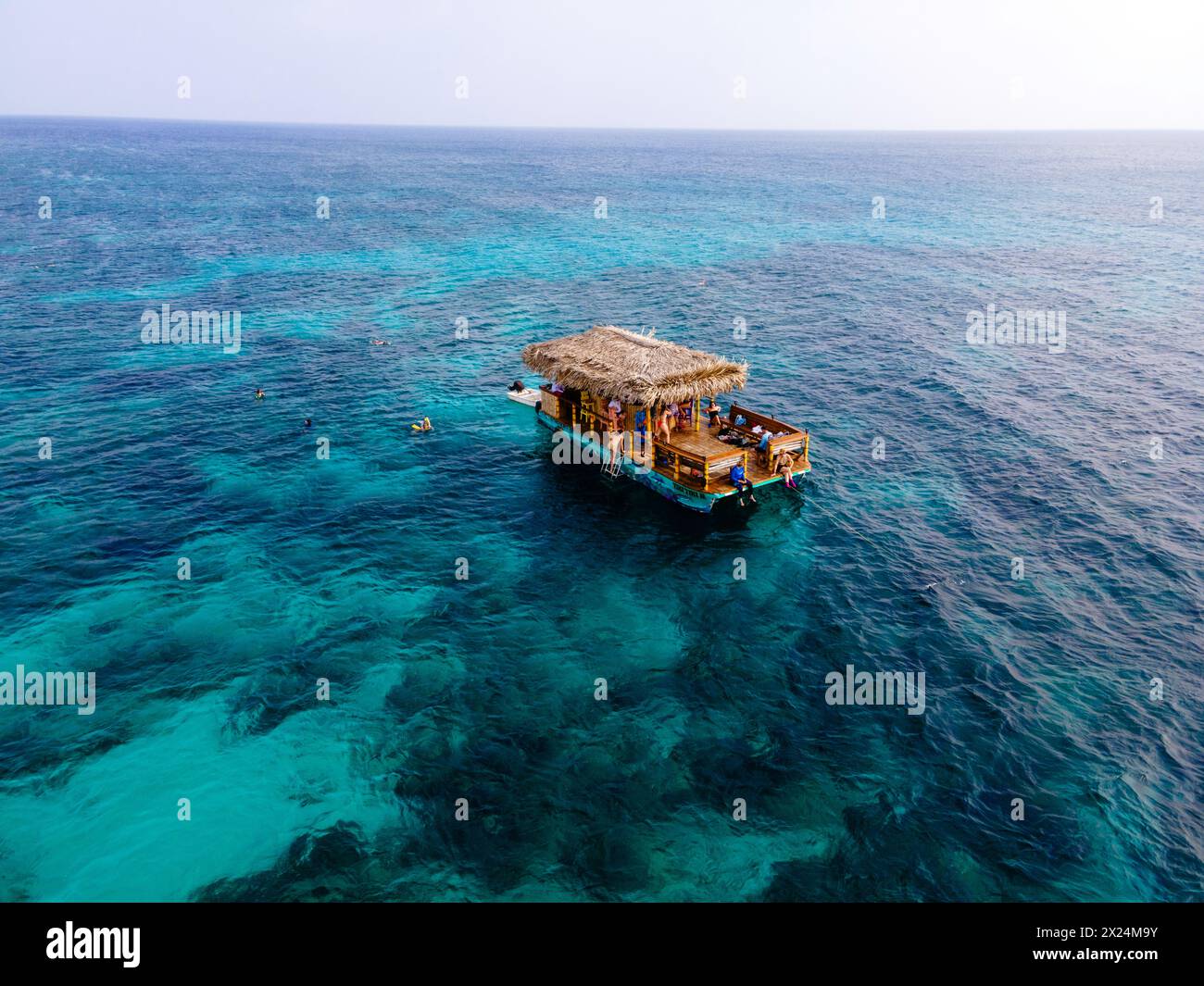 Aerial photograph of people snorkeling from a tiki boat near Fort ...