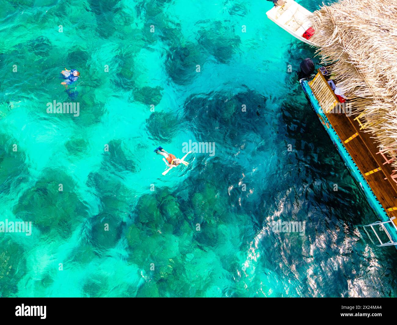 Aerial photograph of people snorkeling from a tiki boat near Fort ...