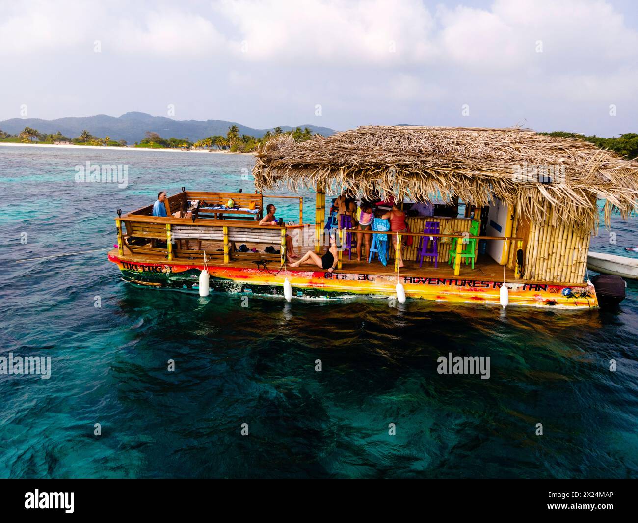 Aerial photograph of people on a tiki boat near Fort Morgan Island ...
