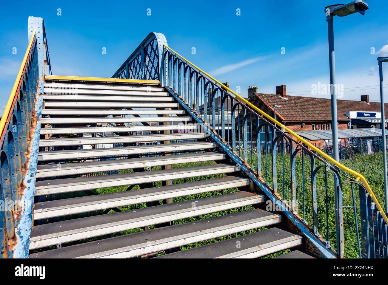 Stairs leading up to a footbridge which spans the railway station at ...
