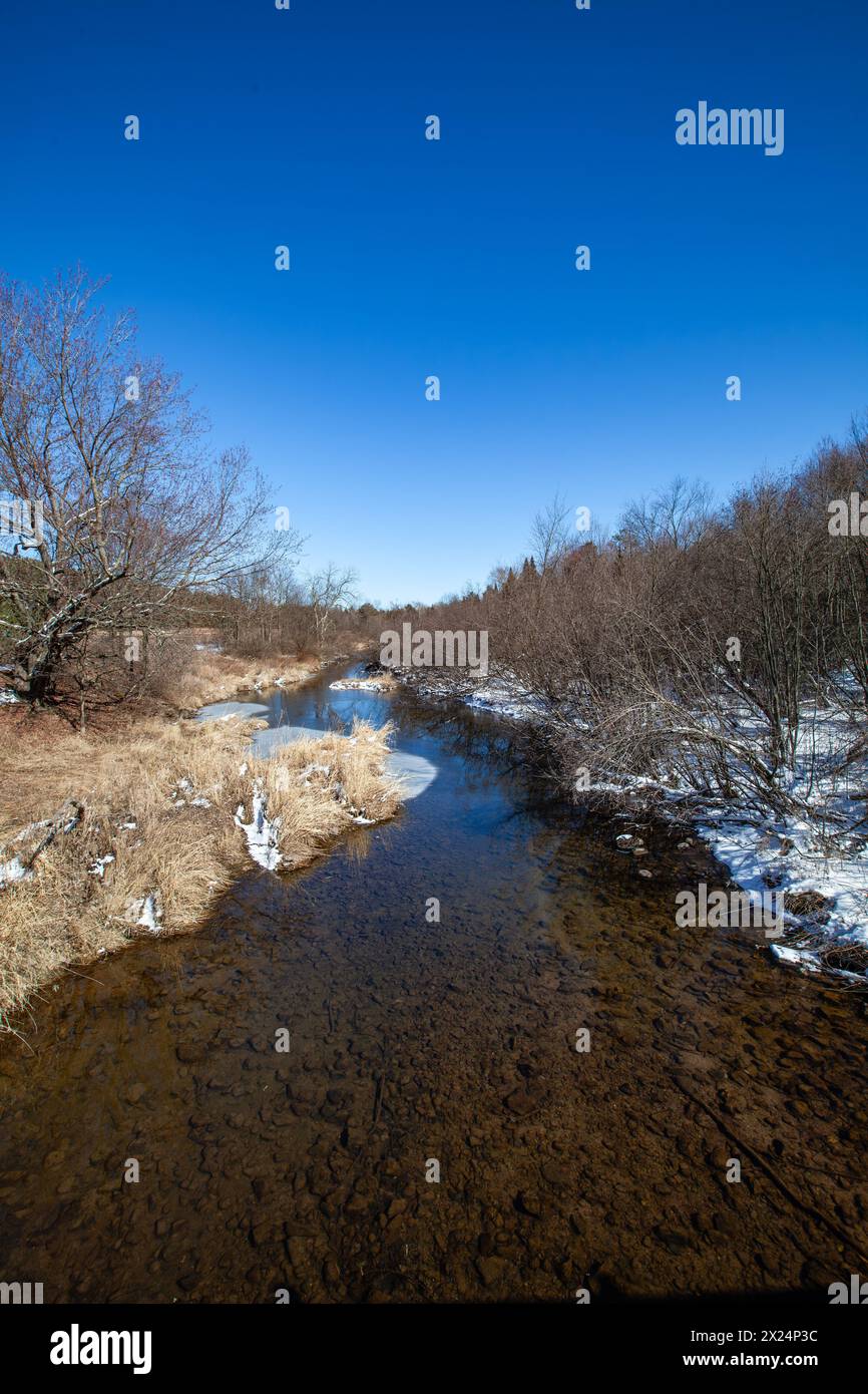 Wisconsin stream and forest with a little snow, vertical Stock Photo ...