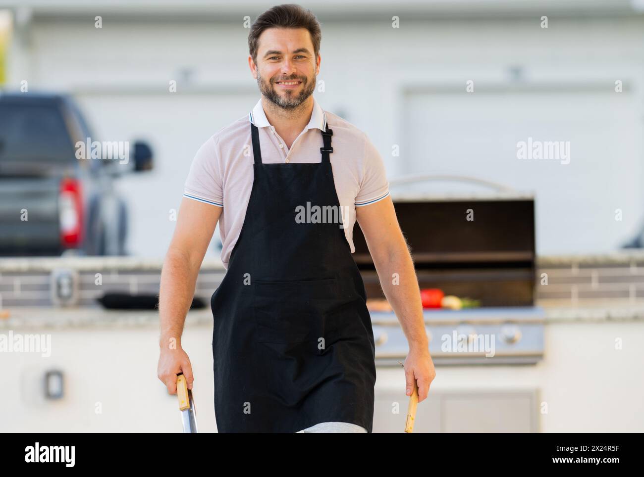 Grill cook. Chef with BBQ cooking tools. Barbecue and grill. Picnic and ...