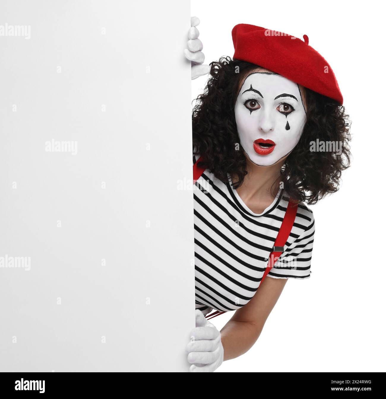Funny mime with blank poster posing on white background Stock Photo - Alamy