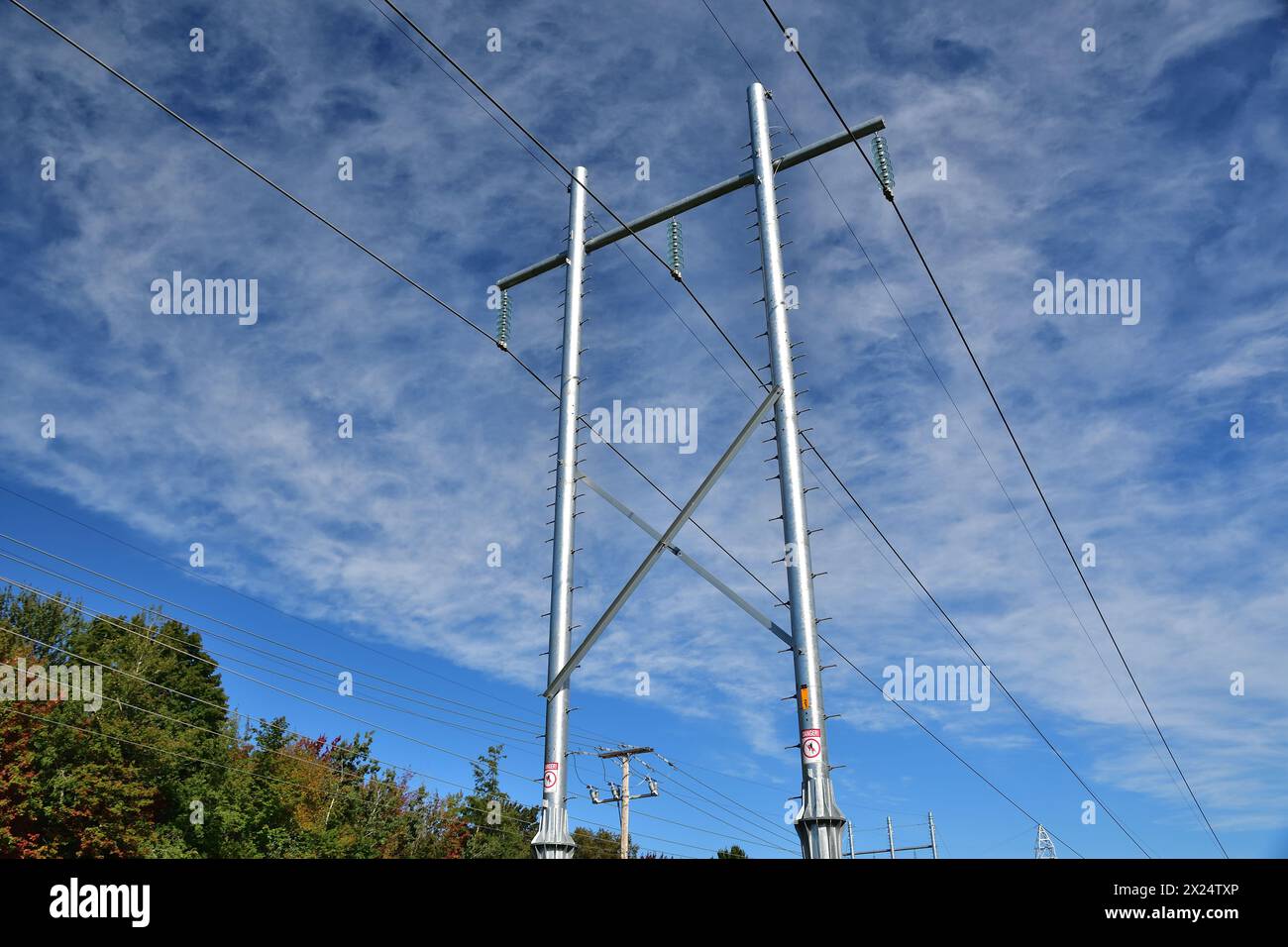 High voltage power line on galvanized round metal post Stock Photo - Alamy