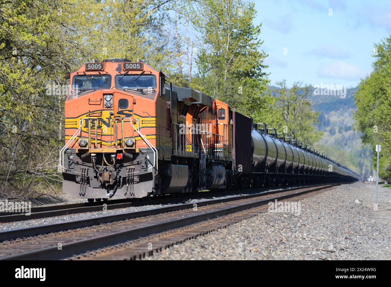 Gold Bar, WA, USA - April 17, 2024; BNSF petroleum crude oil rail shipment of train tankers in ...