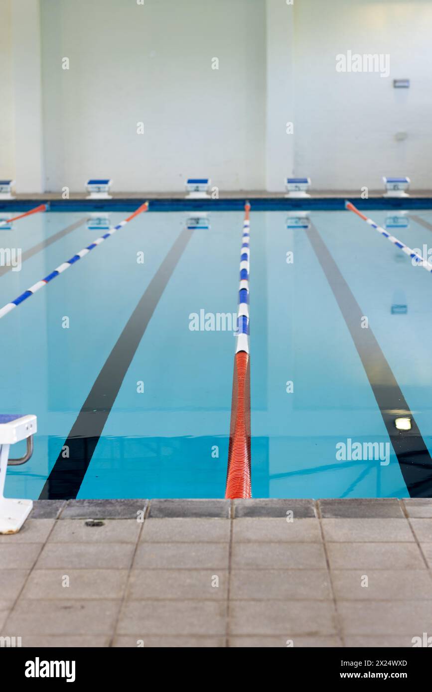 Empty swimming lanes indoors await swimmers, marked by colorful ...